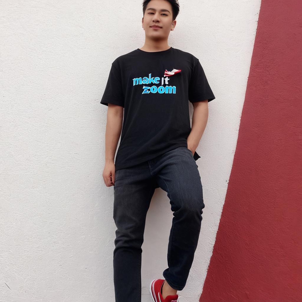 Urban Chill: Young Man in Stylish Black Outfit Against Red Wall