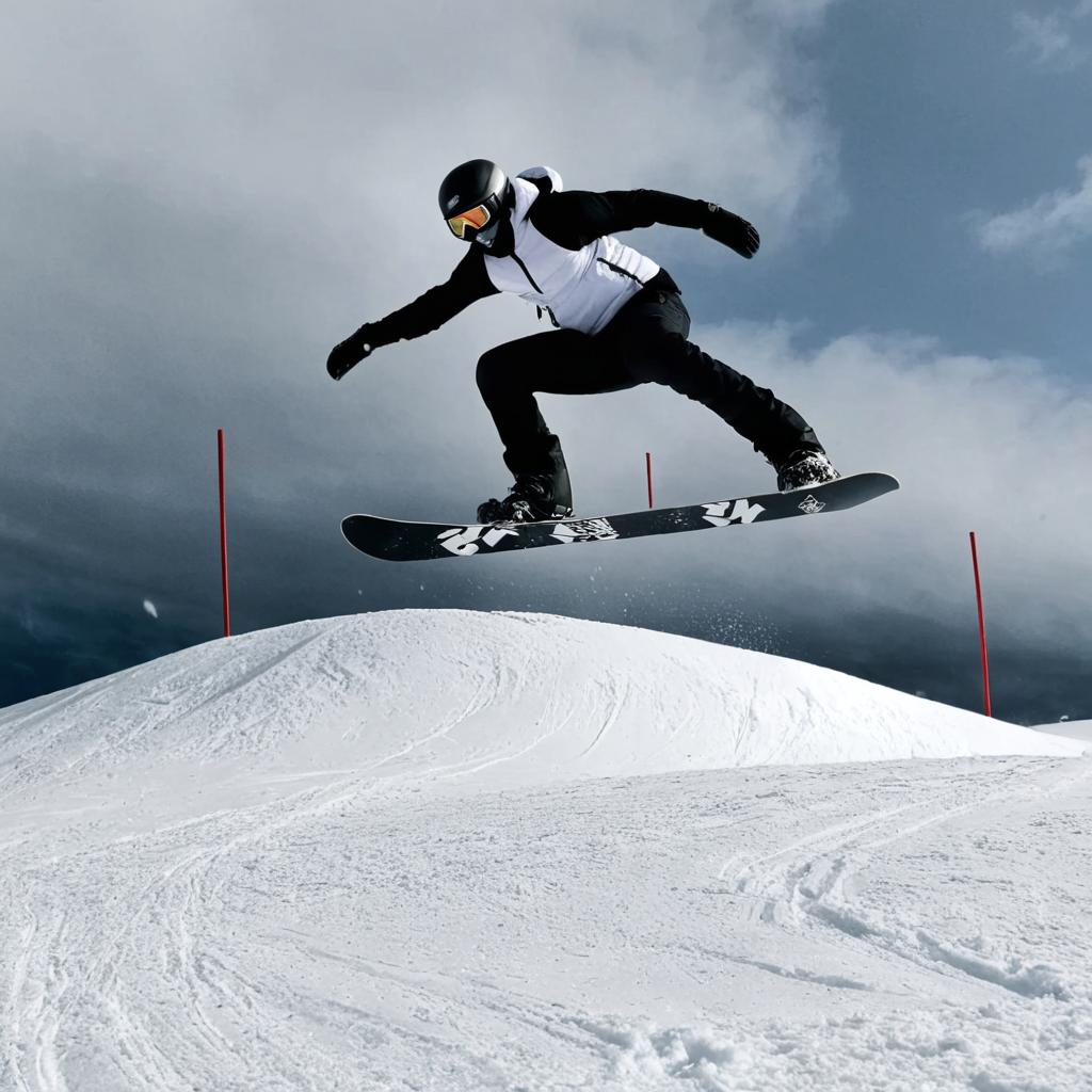 Epic Snowboarding Action: Tail Grab Mid-Air Capture
