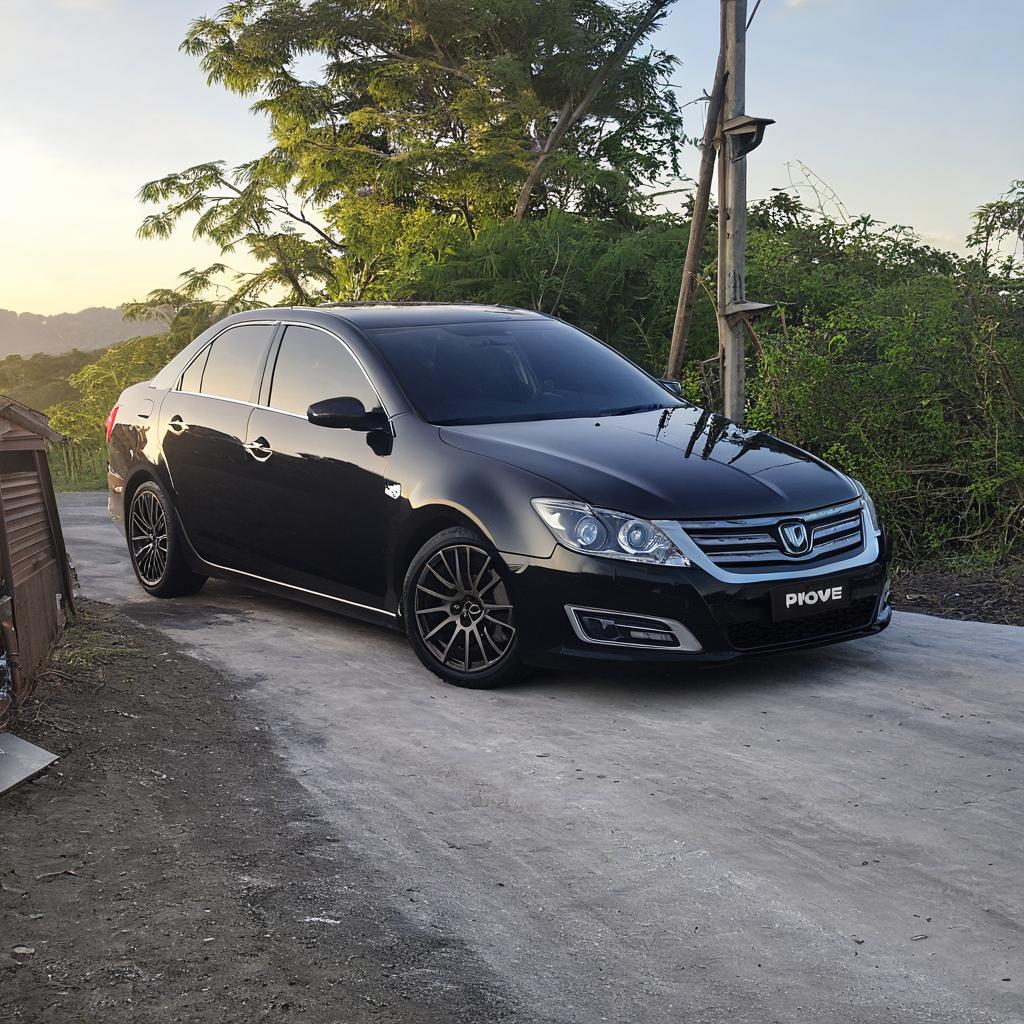 Sleek Black Car at Sunrise: A Stunning Contrast with Nature