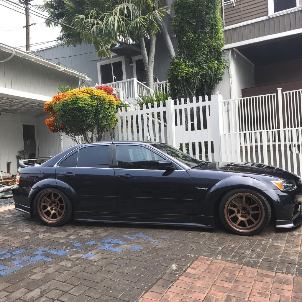 Sleek Modified Car Showcase: Sporty Black Beauty with Bronze Wheels