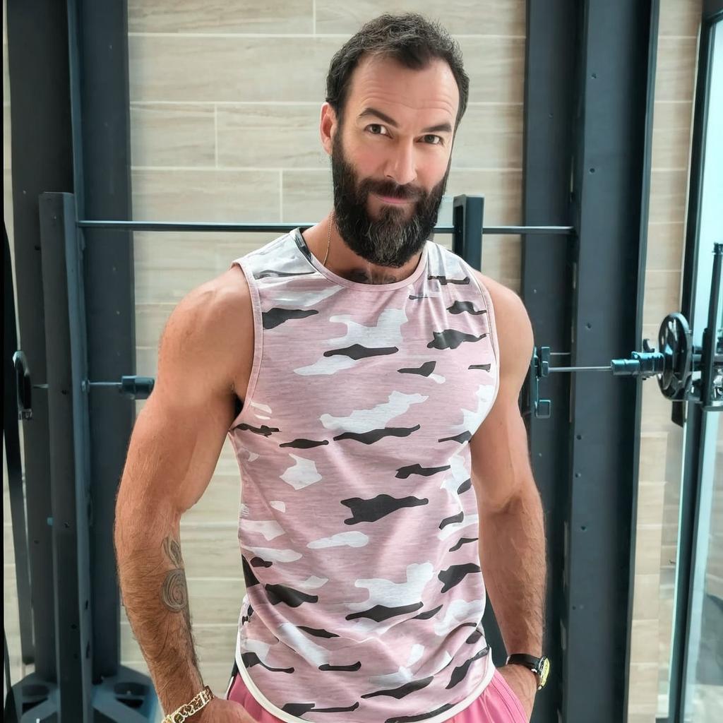 Confidence in Contrast: Muscular Man Rocks a Pink Dress in the Gym